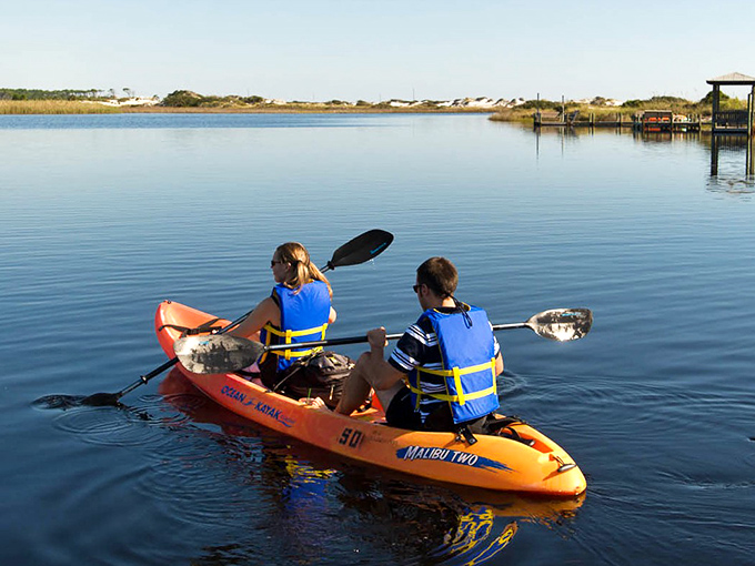Nature's mirror at dawn. Western Lake's glass-like surface transforms kayaking from mere recreation into a transcendent experience.