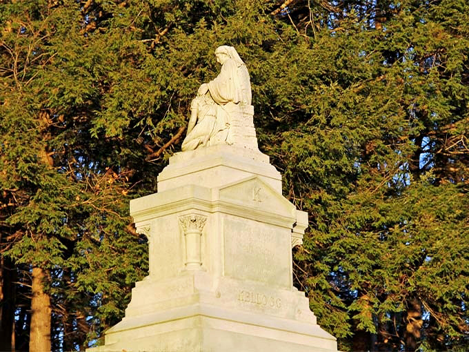 Dignified and commanding, this monument honors one of Vermont's prominent families with classical elegance against evergreen sentinels.