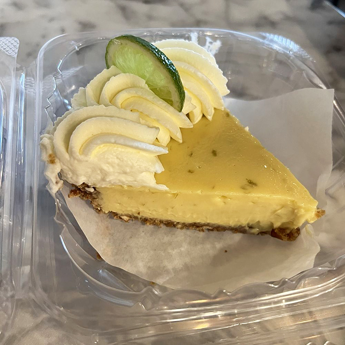 Sunshine in pie form! Tangy lime filling with a dollop of whipped cream and lime garnish on a buttery crust.
