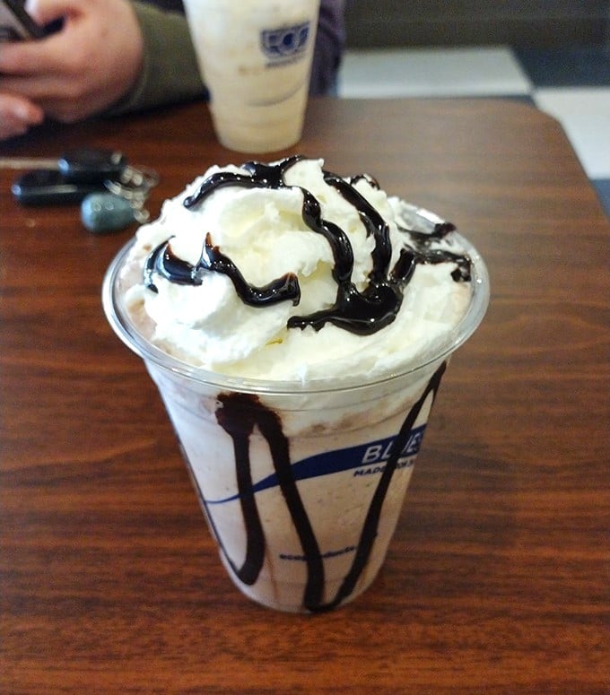 Whipped cream mountains and chocolate drizzles transform this drink into a dessert disguised as coffee.