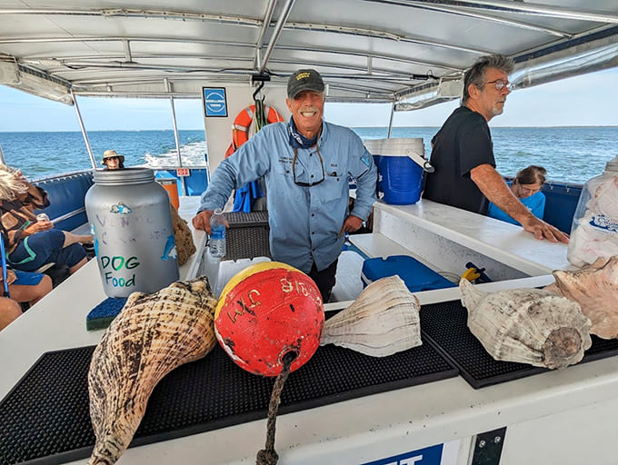 The captain shares fascinating finds with passengers, displaying the impressive shells and marine artifacts that make these waters so special.