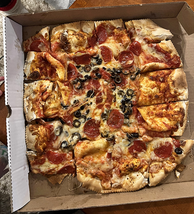 This deluxe pizza showcases Jimmy's commitment to generous toppings and that perfect Wisconsin cheese pull we all crave.