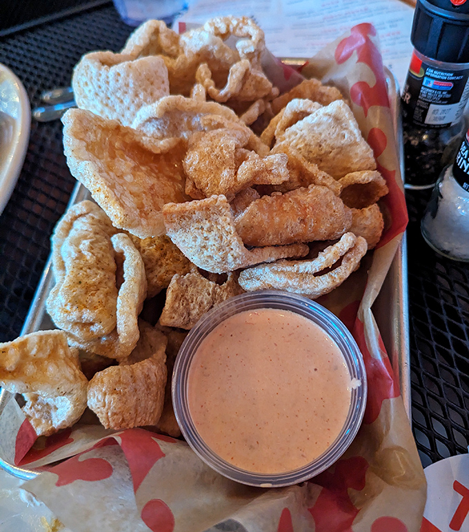 Forget everything you thought you knew about pork rinds – these airy, crunchy clouds come with a dipping sauce that'll make you question your life choices.