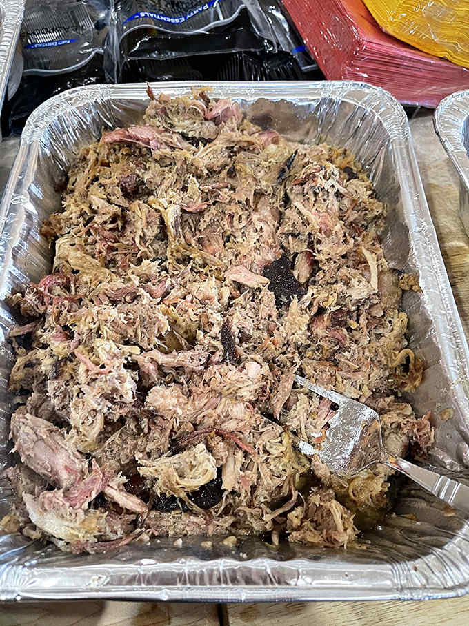 Pulled pork so perfectly shredded it looks like it's auditioning for a food magazine cover, each strand a testament to patience and technique.
