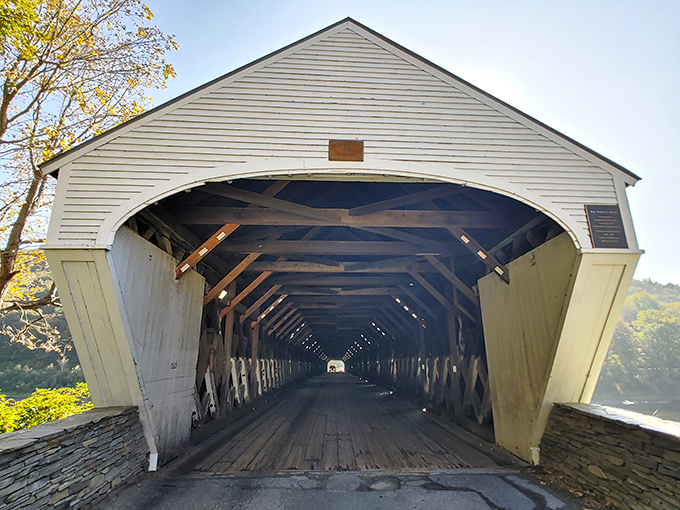The bridge's elegant wooden entrance beckons travelers into its time-capsule interior, promising a journey through both space and history.