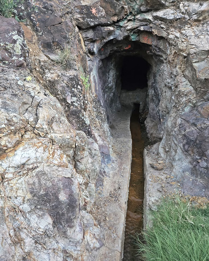 Nature carved this doorway into the mountainside, a mysterious portal leading to underground thermal treasures.