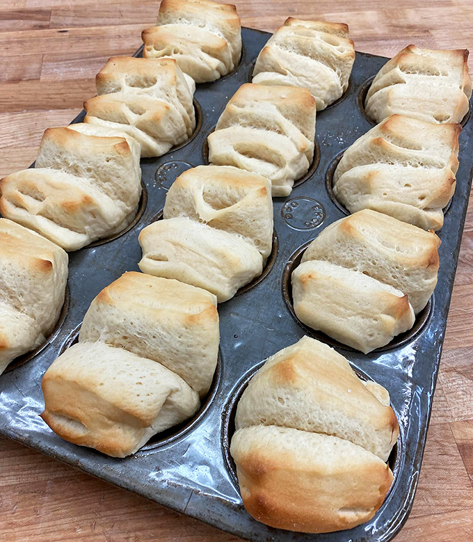 These aren't just rolls &ndash; they're buttery architecture, each fold and twist creating perfect pockets for capturing melted butter or homemade jam.