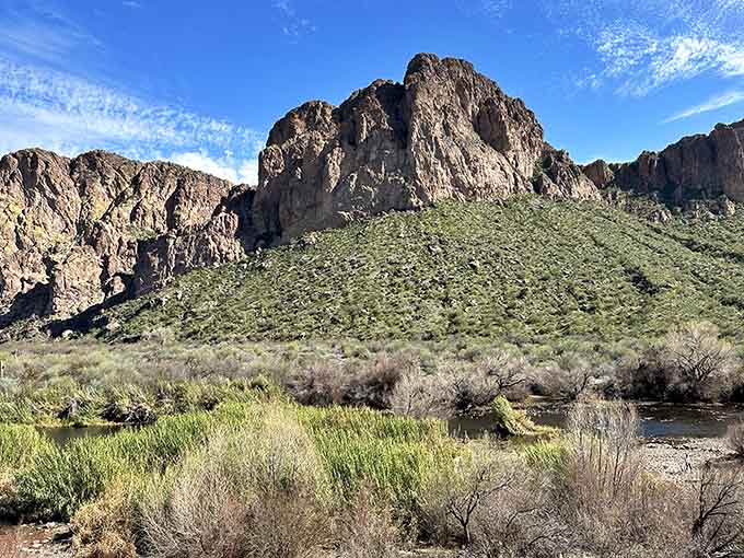 Rock formations tower over the lake like ancient skyscrapers, reminding visitors that this landscape was doing dramatic long before humans showed up.