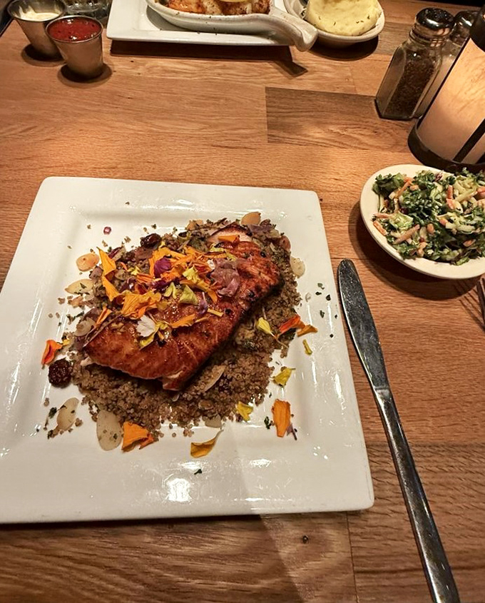 Perfectly seared salmon rests on a bed of quinoa, adorned with colorful vegetables &ndash; proof DiMillo's excels beyond lobster.