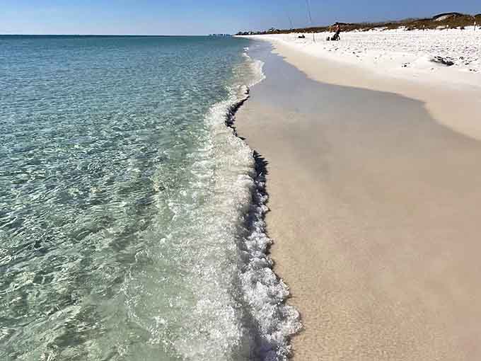 The shoreline where two shades of perfect meet &ndash; crystal clear waters gently lapping at beaches that gleam like fresh snow.