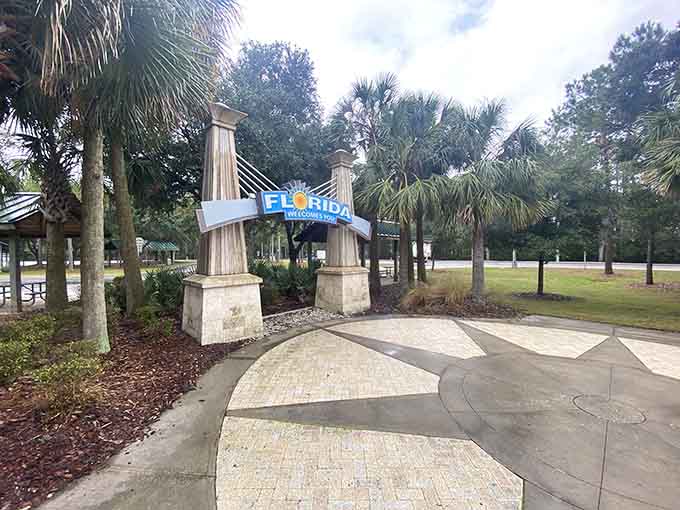 Palm trees frame the welcome sign like nature's own picture frame, because Florida never misses an opportunity to remind you where you are.