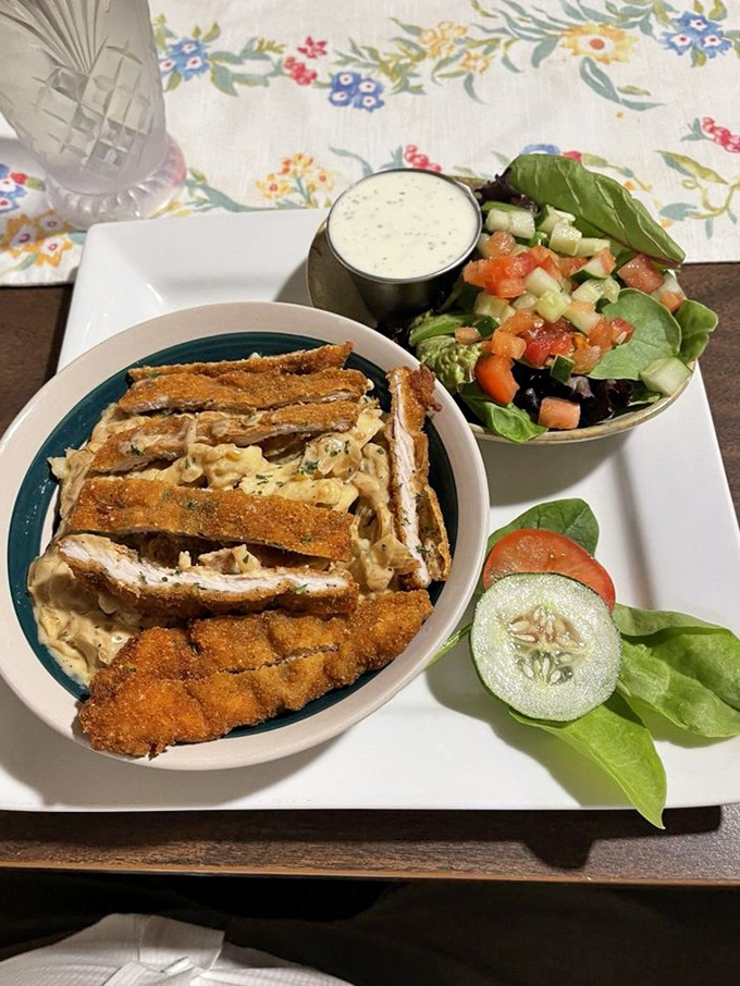 Spaetzle swimming in savory sauce with perfectly breaded schnitzel &ndash; a plate that whispers "Willkommen" to your taste buds with every bite.