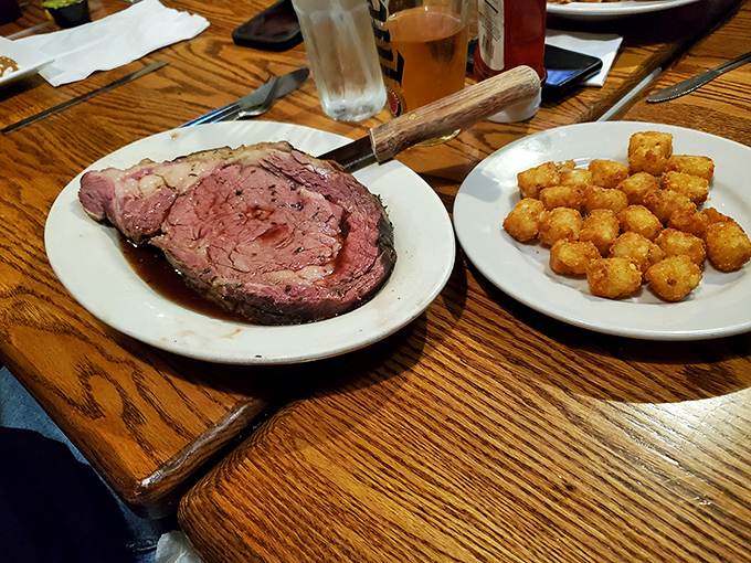 Prime rib so tender you could cut it with a whisper, served alongside golden tater tots that crunch with satisfying precision.