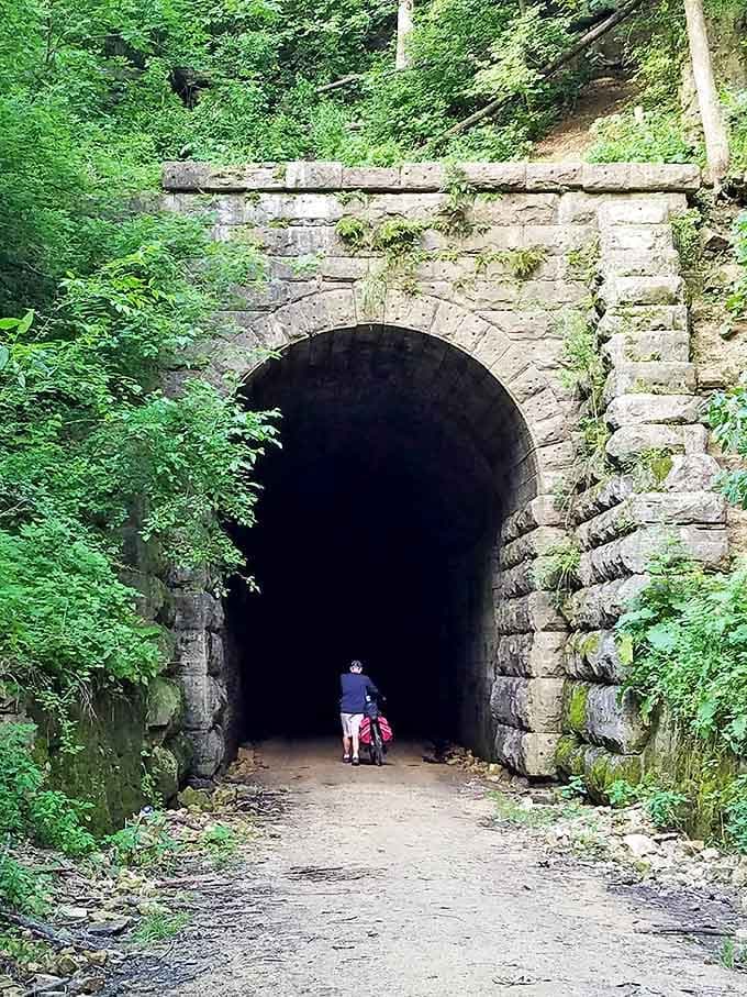 Scale becomes apparent when human silhouettes meet this limestone giant, a reminder of our temporary place in history.