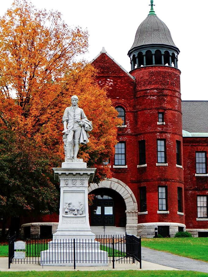 Vermont History Center's stunning red brick architecture houses treasures from the state's past, standing proud against autumn's vibrant backdrop.