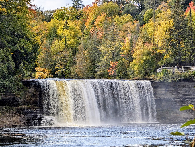 The waterfall's perfect curtain effect happens when water volume is just right, creating this smooth, unbroken sheet that photographers travel hundreds of miles to capture.