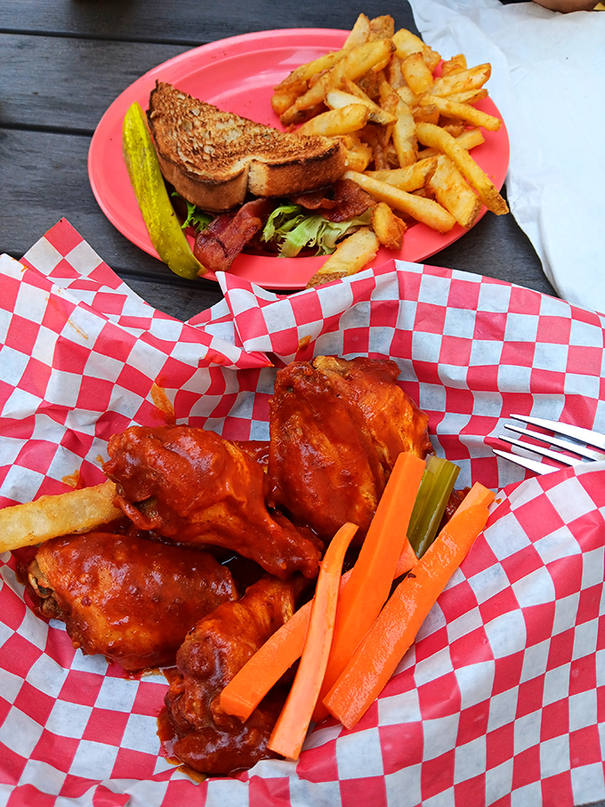 Buffalo wings glowing with tangy sauce promise a flavor explosion &ndash; served with cooling veggies and dip to extinguish the delicious fire.
