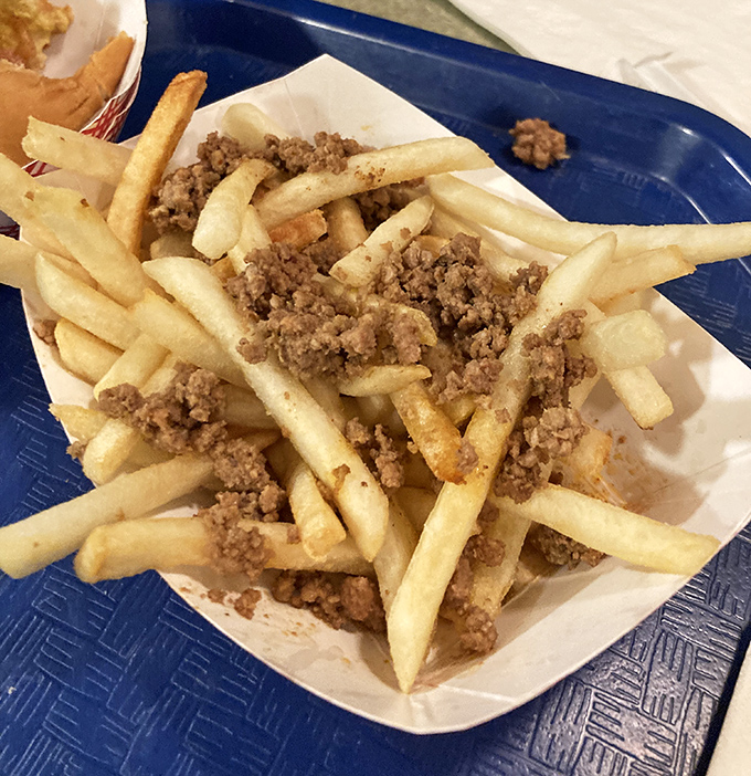 French fries topped with seasoned ground meat and cheese create the kind of indulgence that makes diets weep.