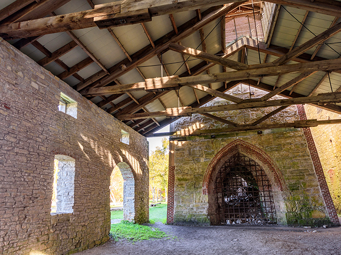 Sunlight streams through the skeletal remains of the blast furnace, creating a cathedral-like atmosphere in this once-fiery industrial heart.