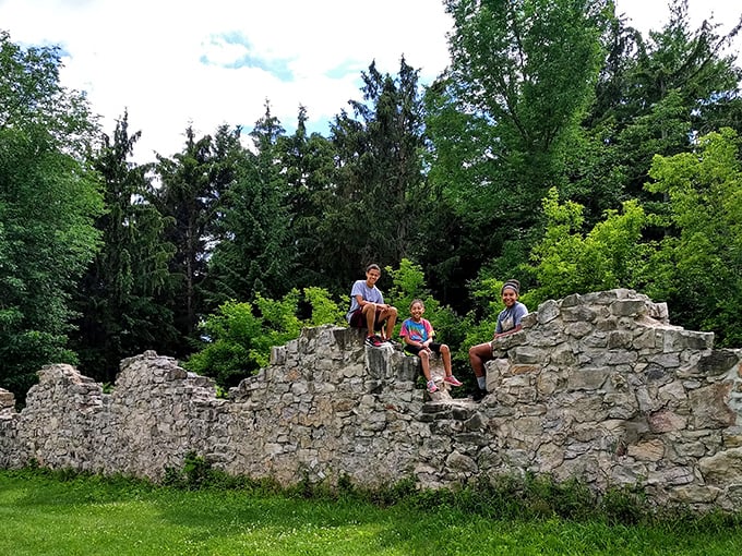 Young explorers claim their stone thrones atop the ruins. Nothing says "family vacation" like conquering a possibly haunted hotel together!