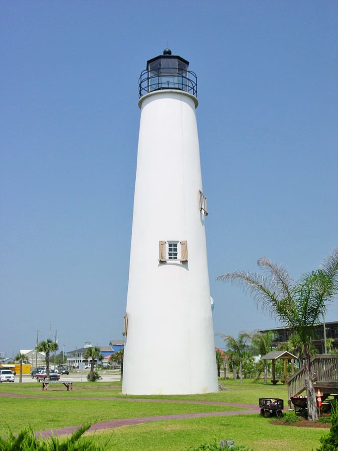 The iconic white beacon of St. George Island Lighthouse stands tall against the blue sky, a maritime sentinel since 1833.