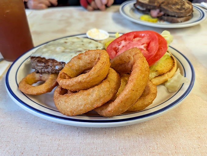 Golden, crispy onion rings that shatter satisfyingly with each bite &ndash; proof that sometimes the simplest diner classics are the most satisfying.