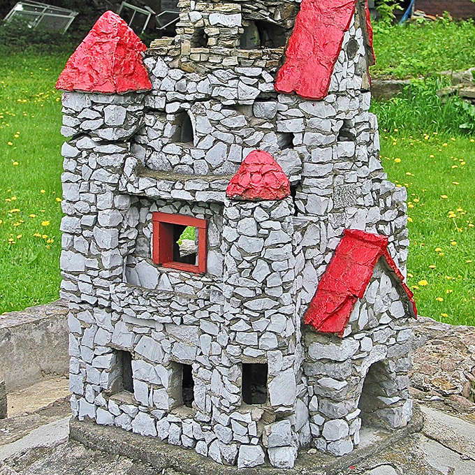 Red-roofed wonder: Bold color choices make this particular castle pop against its stone construction &ndash; architectural whimsy at its finest.