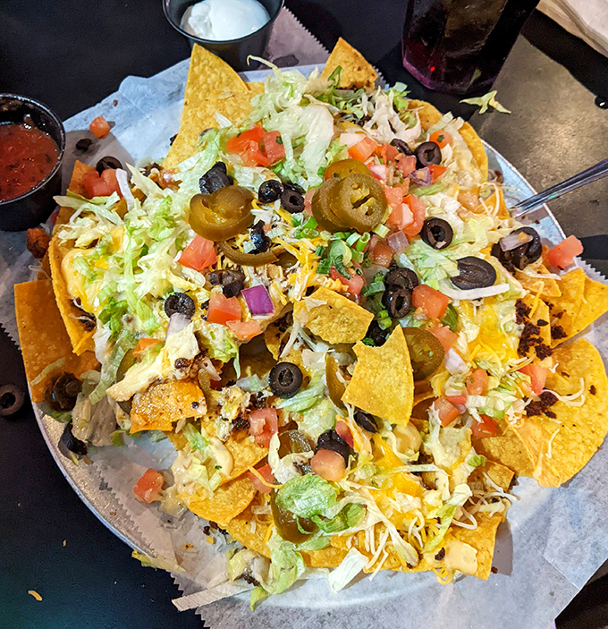 The Super Nachos Grande isn't just a meal – it's a topographical wonder with valleys of guacamole and peaks of sour cream.