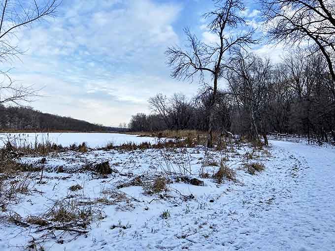 Winter transforms the landscape into a serene wonderland, with snow dusting the shores of the frozen lake at Crosby Farm.