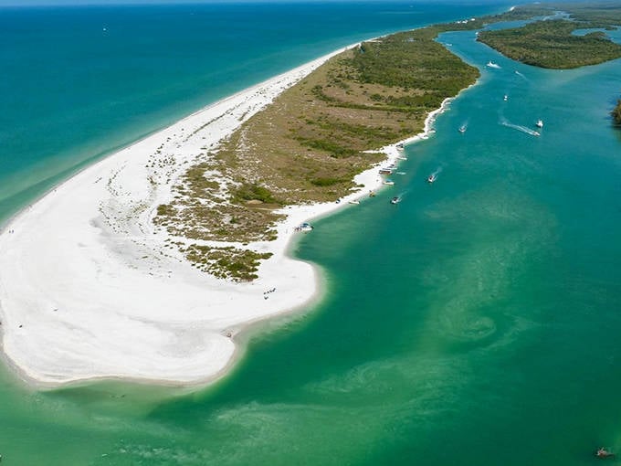 Keewaydin Island's pristine shoreline glows with golden-white sand, creating a paradise only accessible to those who arrive by boat.