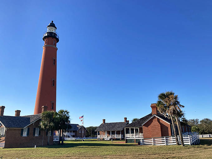 Ponce De Leon Inlet Light towers above the surrounding landscape as Florida's tallest lighthouse. Its brick-red exterior has guided mariners for generations.