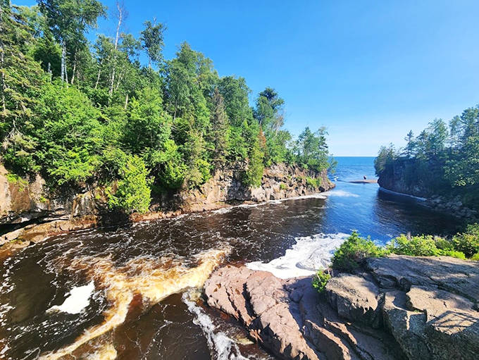 Rushing waters carve through rocky shores in Superior National Forest, creating natural water features that captivate visitors without costing a cent.