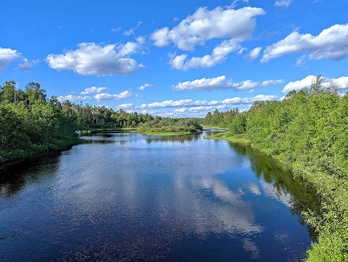 Superior National Forest's pristine lakes reflect perfect blue skies, surrounded by lush greenery in a wilderness playground that's free for all to enjoy.