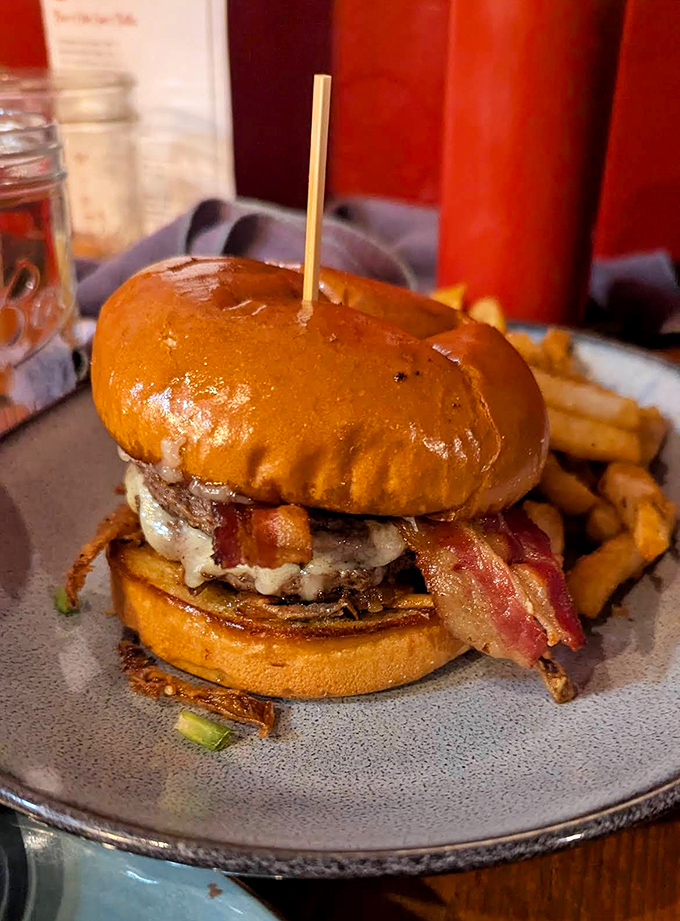This isn't just any burger &ndash; it's a pimento bacon masterpiece with melty cheese cascading down the sides like a dairy waterfall.