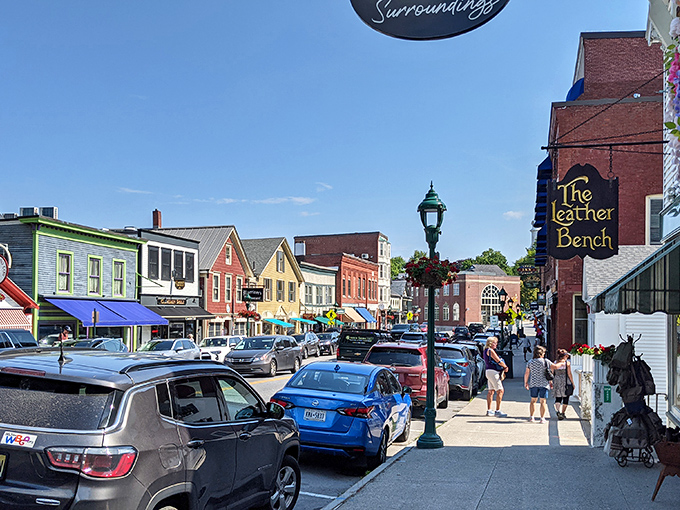 The colorful storefronts of Camden's Main Street invite exploration, where locally-owned shops maintain the town's authentic character despite its postcard fame.