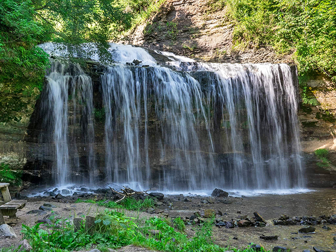 Cascade Falls creates a perfect curtain of water, tucked surprisingly within downtown Osceola like a hidden treasure.