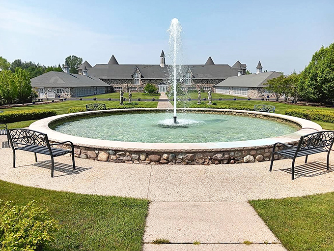 Castle Farms presents an impressive stone facade with a welcoming fountain, its European-inspired architecture creating a magical backdrop for visitors.