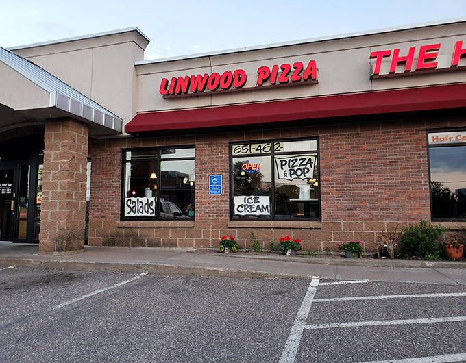 Linwood Pizza's no-frills storefront with hand-painted window signs offers a glimpse into Minnesota's authentic neighborhood pizza tradition.