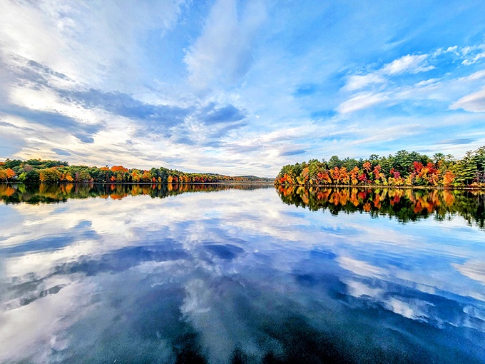 Norway Lake's pristine waters reflect puffy white clouds, creating a swimming spot that feels like dipping into the sky itself. 