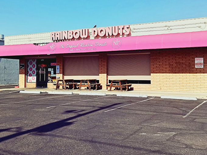 The Original Rainbow Donuts' cheerful pink awning brightens the Phoenix streetscape like a sweet promise.