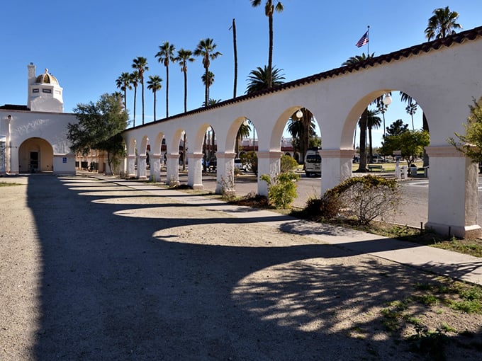 The sun-washed arches of Ajo's historic plaza create perfect frames for blue sky views, showcasing the town's unique architectural heritage.