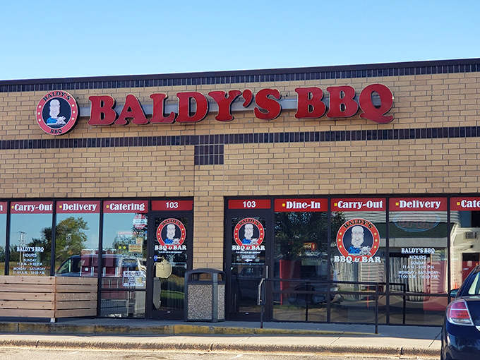 The bold red Baldy's BBQ sign signals salvation for hungry BBQ enthusiasts &ndash; behind those windows awaits tender brisket with the perfect smoke ring.