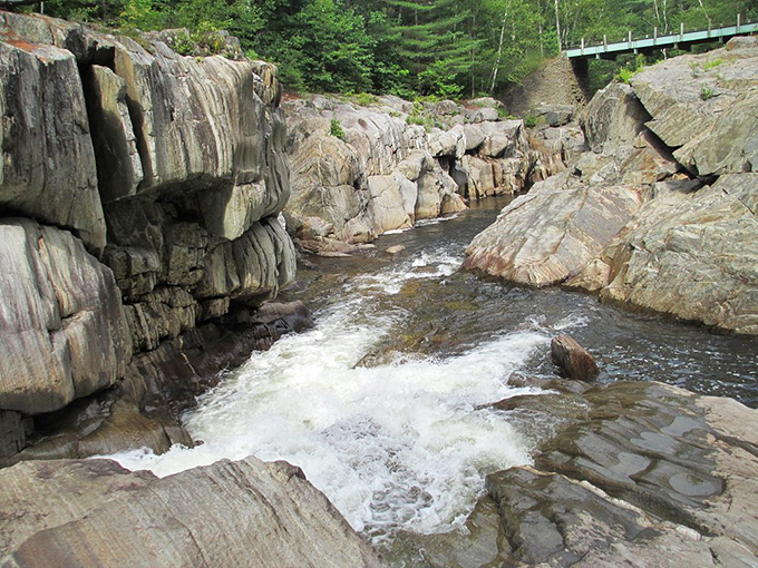 Summer's perfect swimming hole awaits at Coos Canyon, where emerald pools invite brave jumpers from smooth ledges.