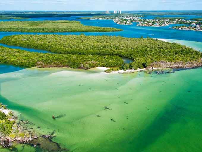 A peaceful beach stretches into the distance, proving the best things in life require a boat ride.