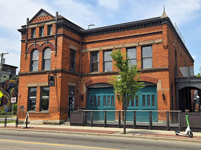 The rustic wooden beams of Mitten Brewing's entrance hint at the warm atmosphere inside, where baseball themes and pizza aromas welcome hungry fans.