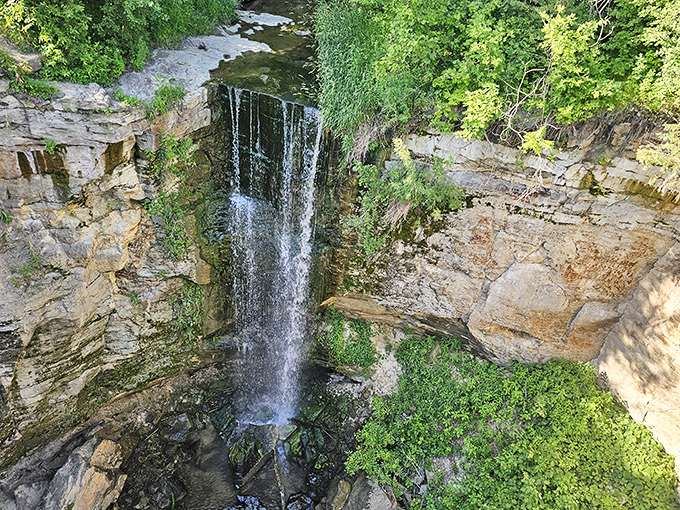 The wide, gentle flow of Minnemishinona Falls creates a soothing scene that invites you to sit, stay, and forget about time.