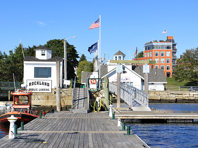 A sunny day illuminates Rockland's vibrant downtown, where historic brick buildings house galleries, shops, and restaurants just steps from the harbor.