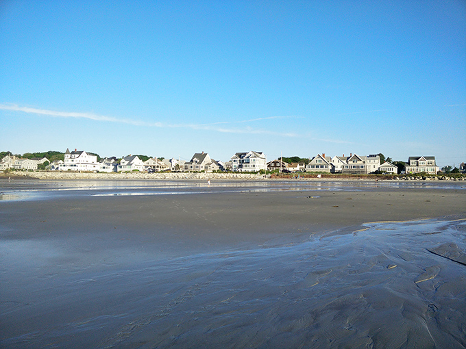 Classic New England beach homes line the shore, their weathered charm perfectly complementing the historic setting.