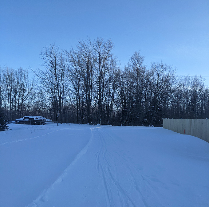 Winter's pristine canvas awaits explorers at the Big Bay Pathway trailhead &ndash; silence so complete you can hear snowflakes landing.