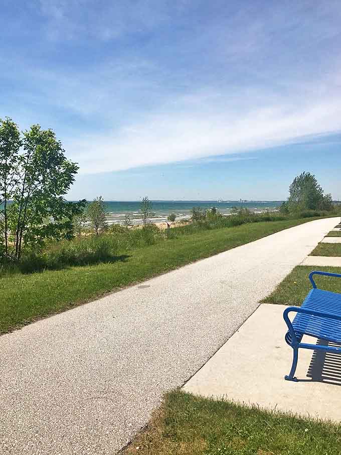 A lone blue bench invites weary travelers to pause and absorb the panoramic lake views &ndash; no reservation required.